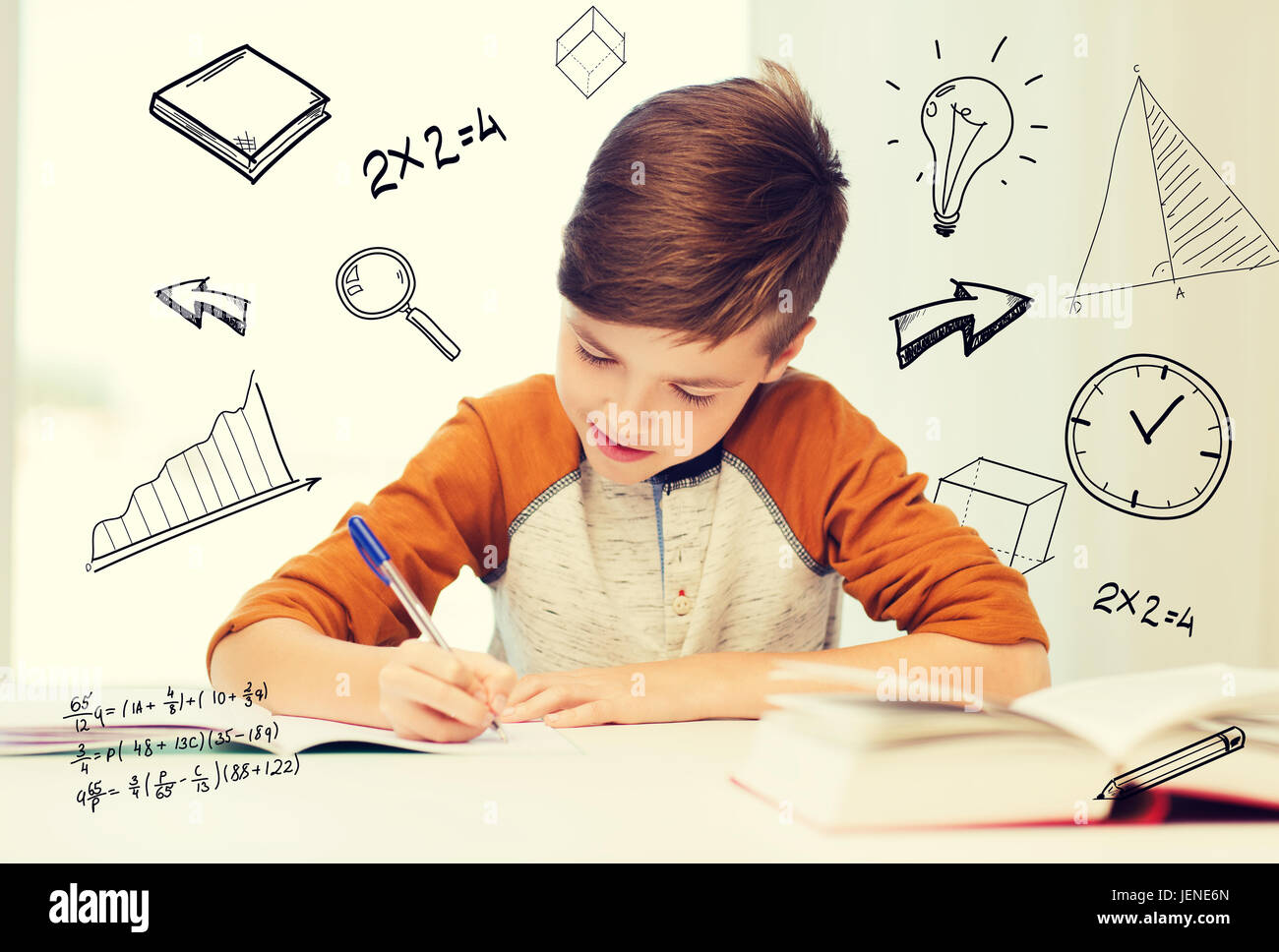 smiling student boy writing to notebook at home Stock Photo - Alamy