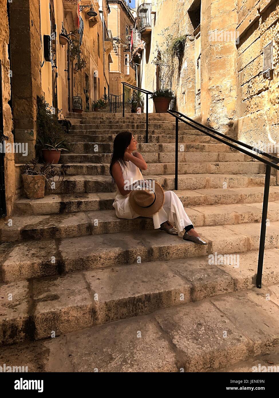 Woman sitting on steps, Valetta, Malta Stock Photo - Alamy