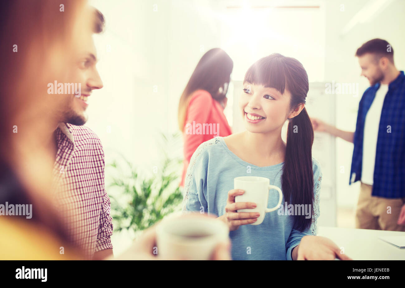 happy creative team drinking coffee at office Stock Photo - Alamy