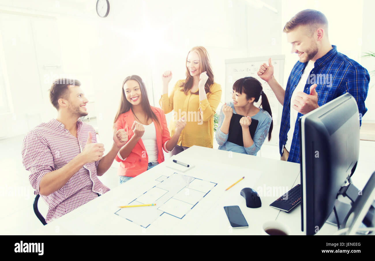 happy creative team celebrating success at office Stock Photo - Alamy
