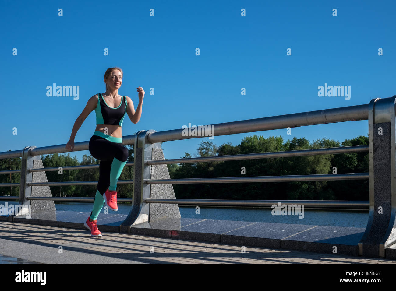 Woman jogging on metal bridge hi-res stock photography and images - Alamy