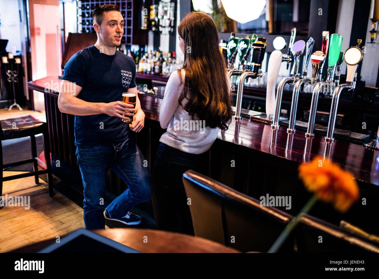 Couple talking in a bar Stock Photo - Alamy