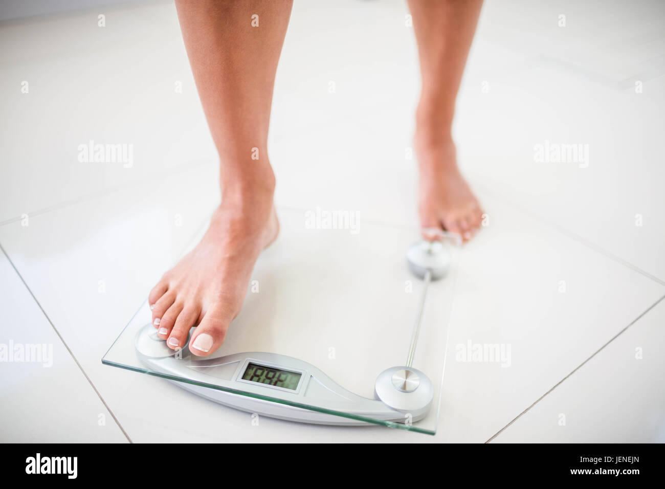 Womans feet going on weighting scale Stock Photo - Alamy