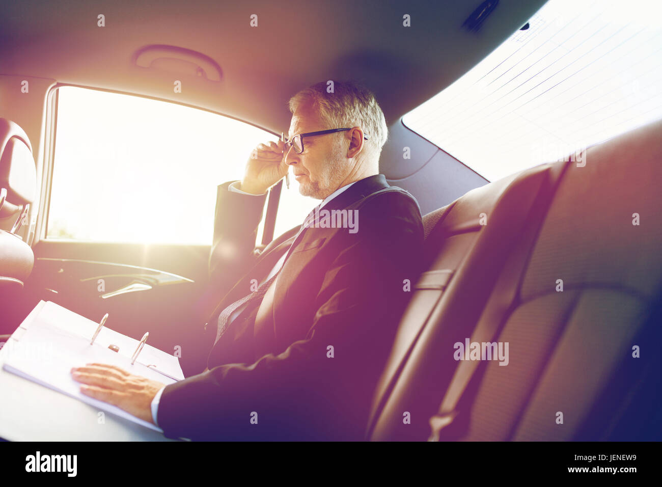 senior businessman with papers driving in car Stock Photo - Alamy