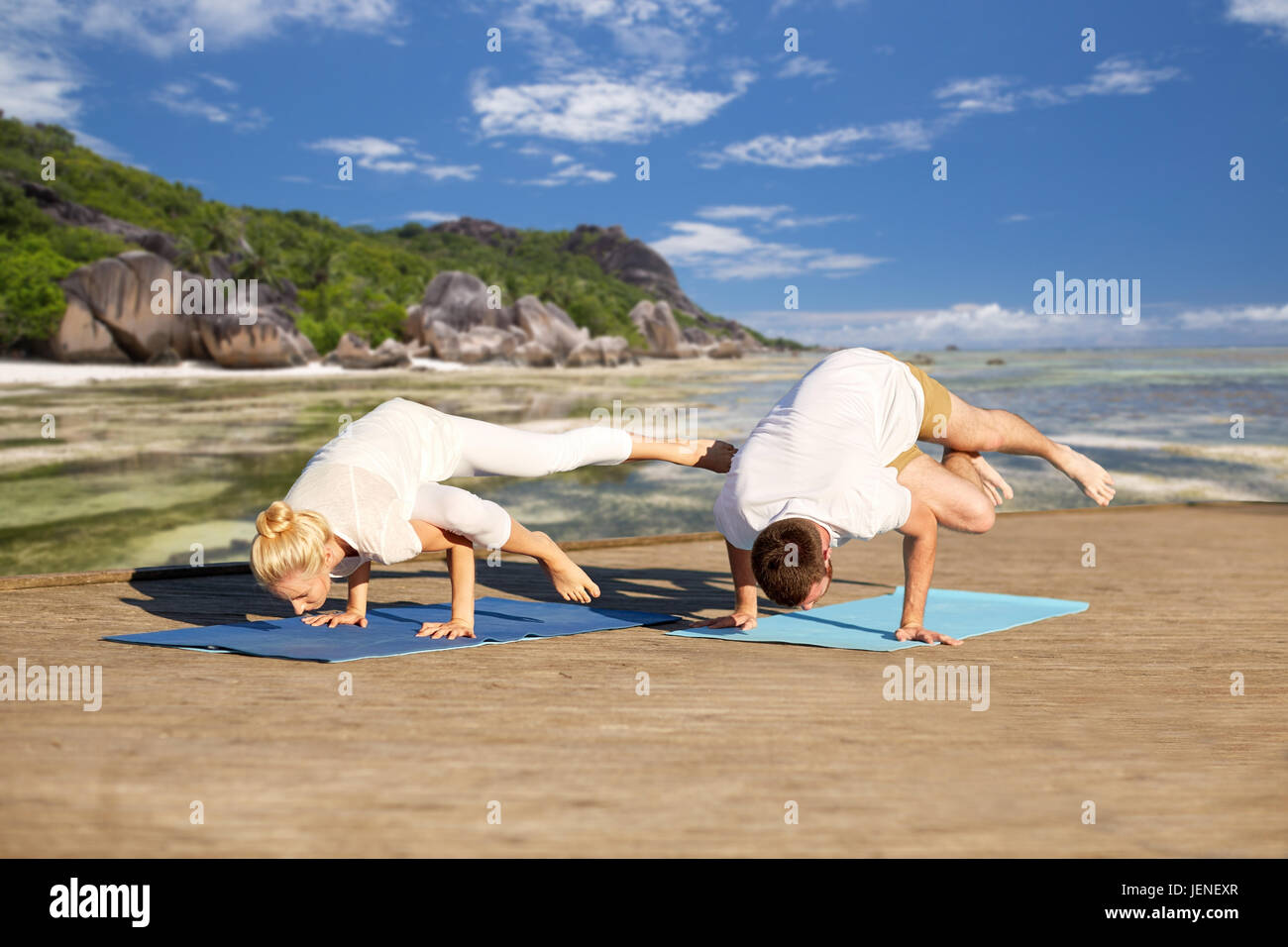 couple making yoga side crane pose outdoors Stock Photo - Alamy