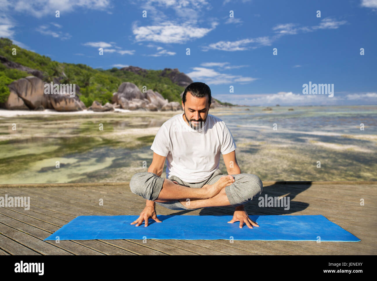 man making yoga in scale pose outdoors Stock Photo - Alamy