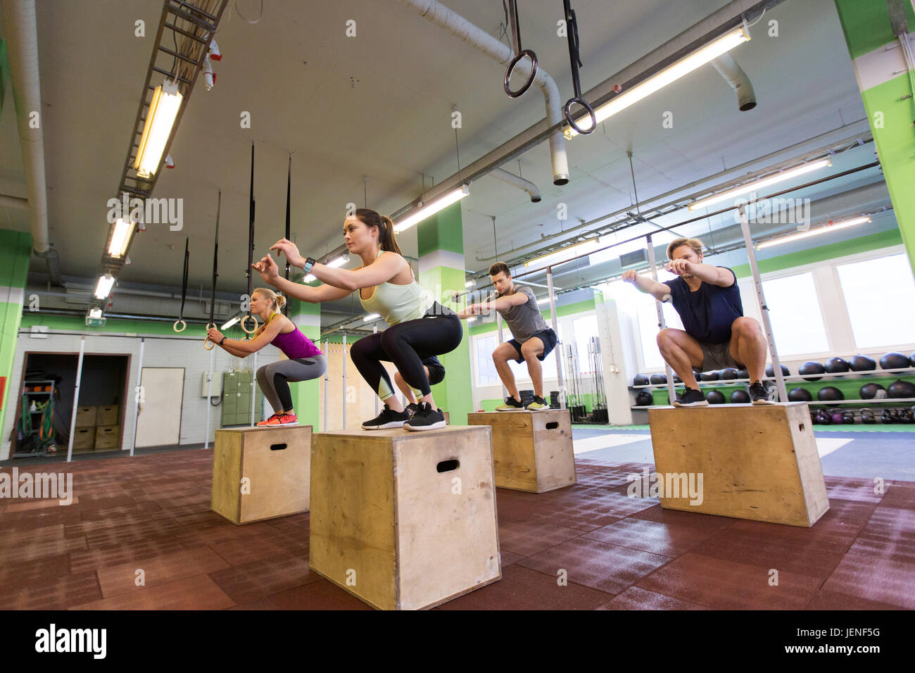 group of people doing box jumps exercise in gym Stock Photo - Alamy