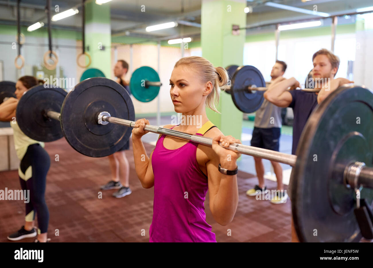 group of people training with barbells in gym Stock Photo - Alamy