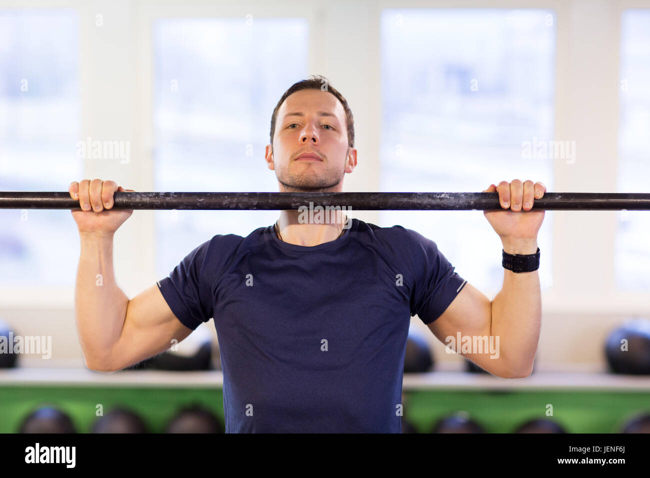 man exercising on bar and doing pull-ups in gym Stock Photo - Alamy
