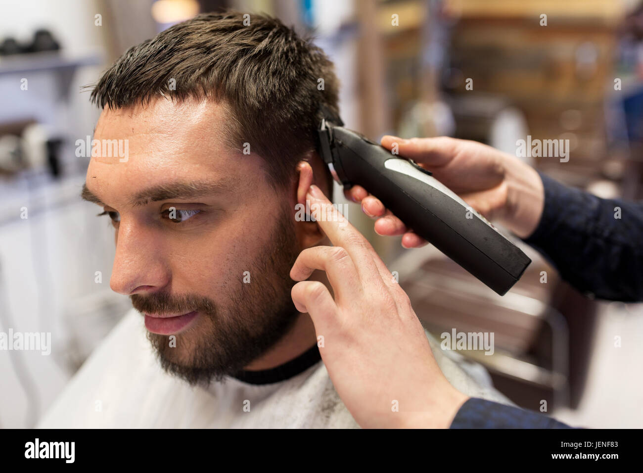 man and barber hands with trimmer cutting hair Stock Photo - Alamy