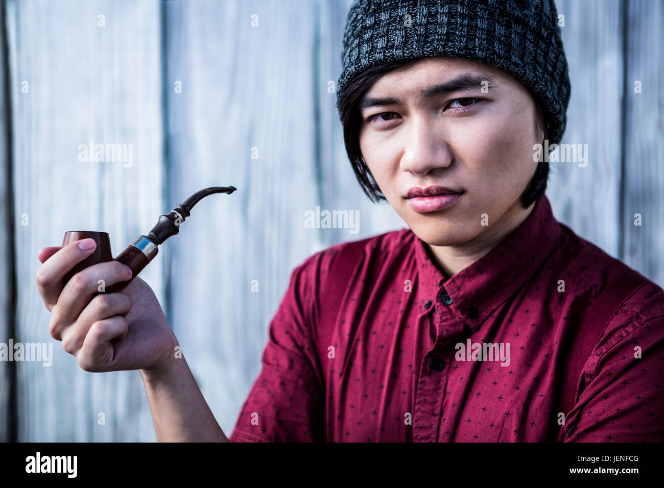 Thoughtful hipster smoking pipe Stock Photo - Alamy