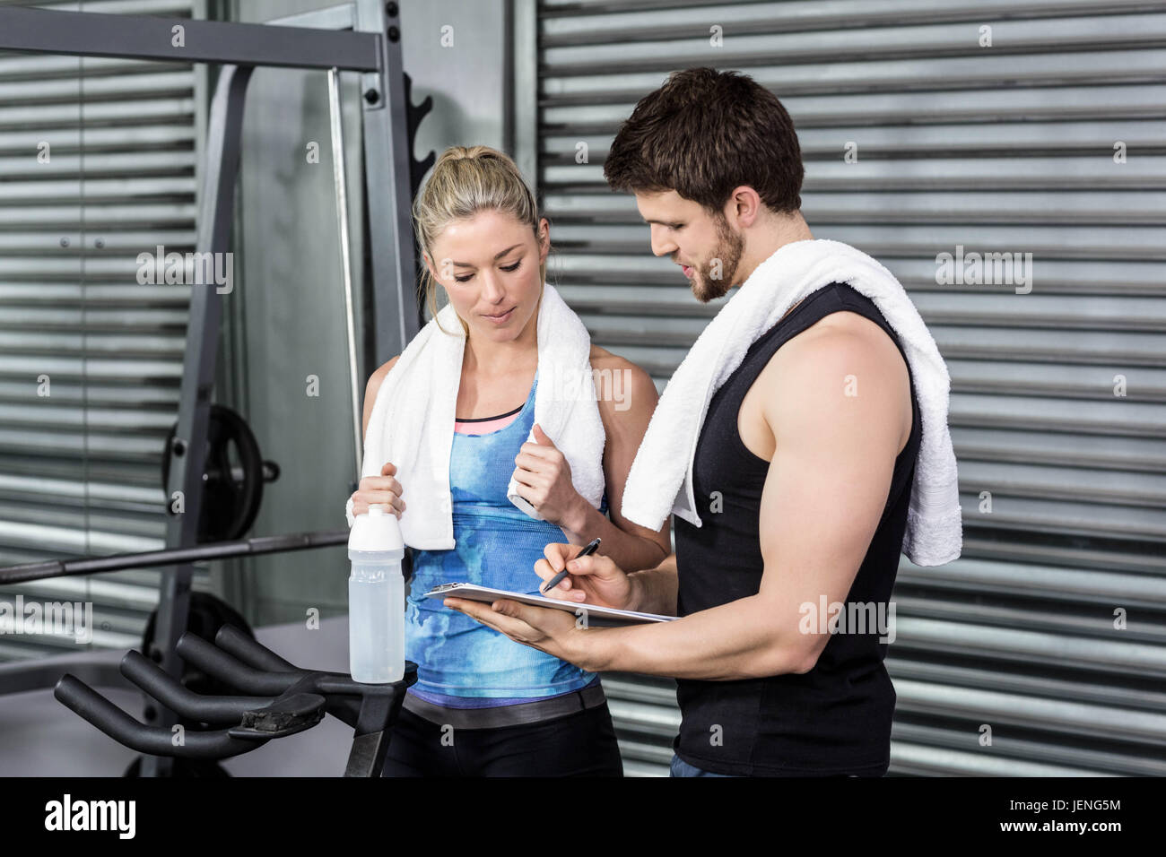 Smiling fit couple taking notes Stock Photo - Alamy