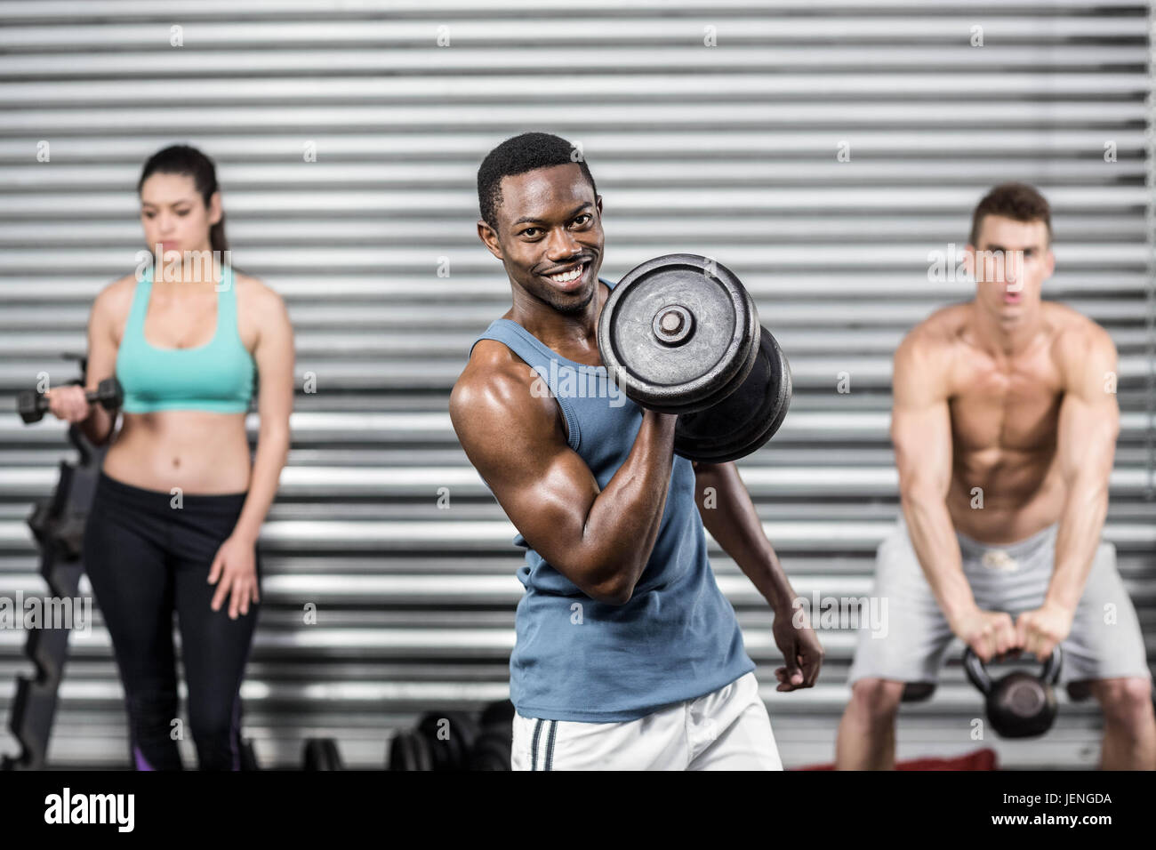 Fit people lifting dumbbells Stock Photo - Alamy