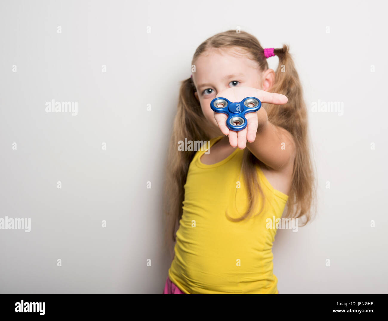 cheerful child with a bright spinner Stock Photo - Alamy