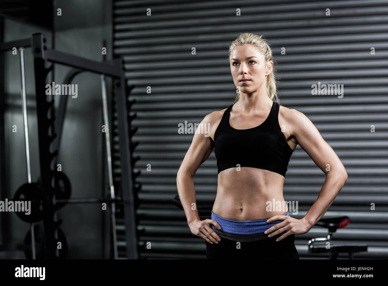 Fit woman with hands on hips Stock Photo - Alamy