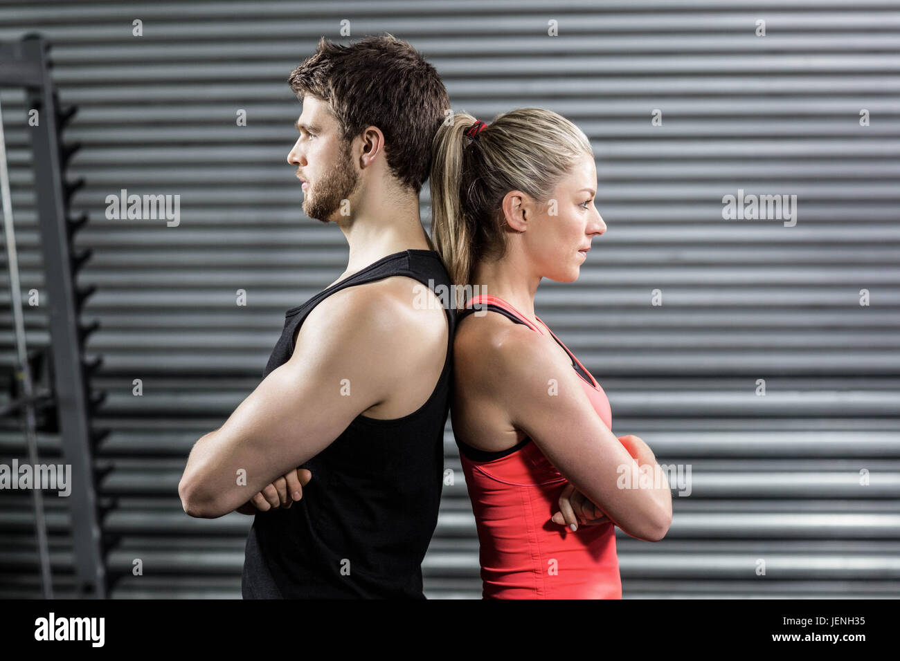 Serious couple standing back to back Stock Photo - Alamy