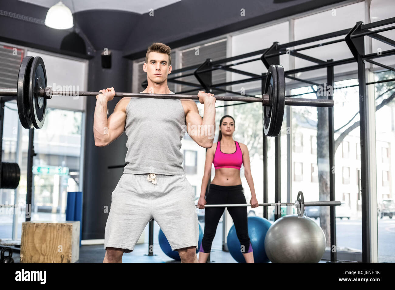 Fit couple lifting barbell Stock Photo - Alamy