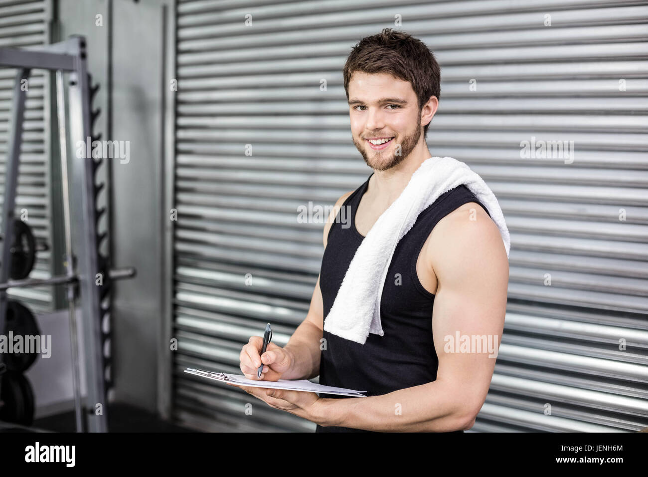 Trainer taking notes at crossfit gym Stock Photo - Alamy