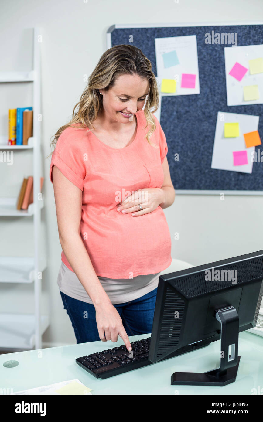 Pregnant woman using computer Stock Photo - Alamy
