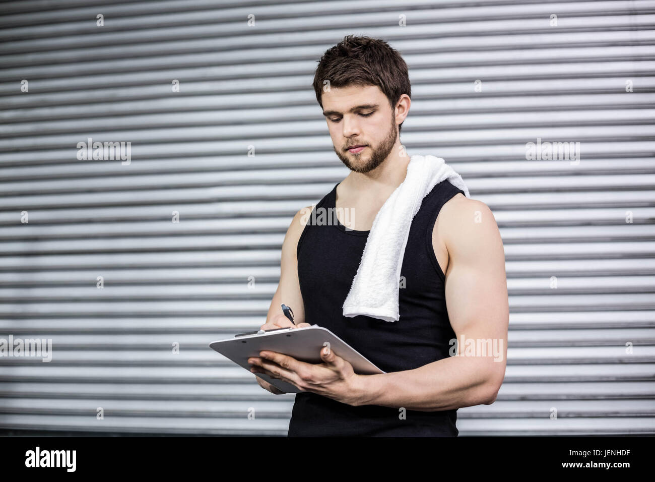 Trainer taking notes at crossfit gym Stock Photo - Alamy