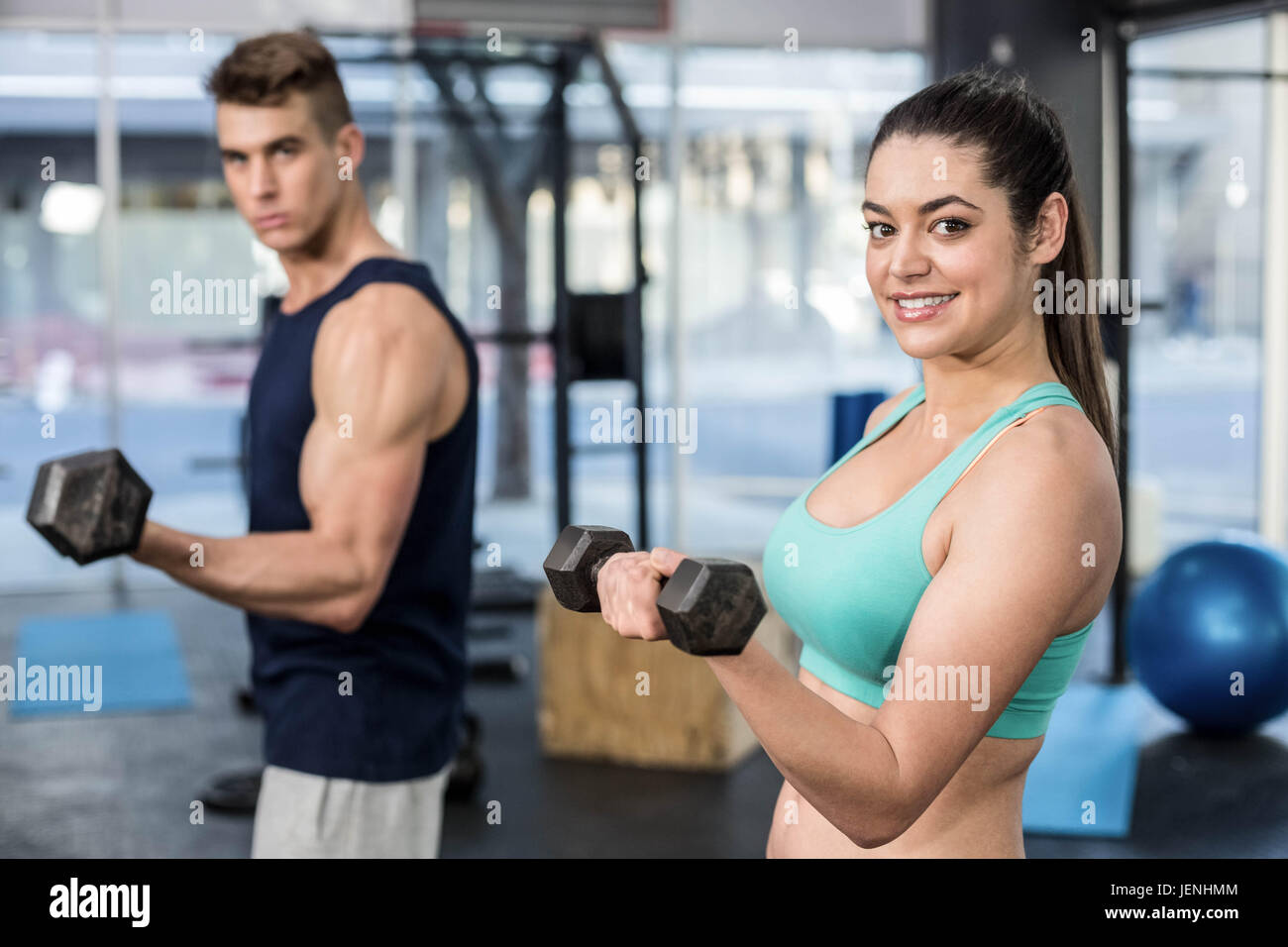 Fit people lifting dumbbells Stock Photo - Alamy