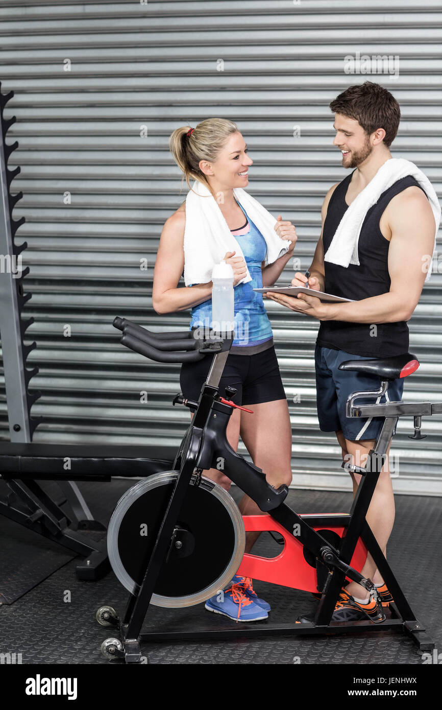 Smiling fit couple taking notes Stock Photo - Alamy