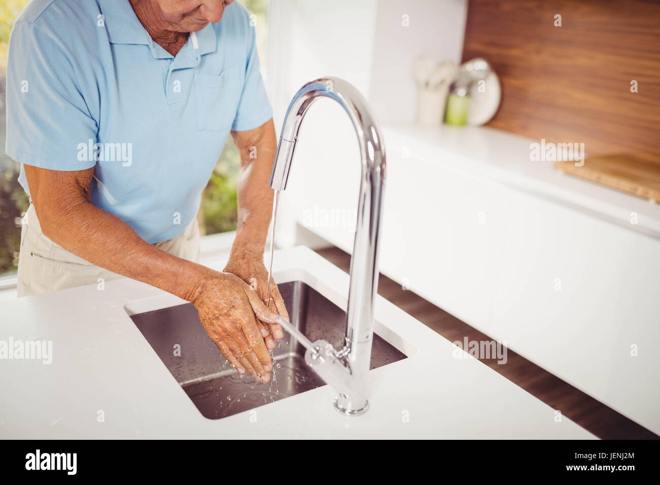 Mid section of senior man washing hands Stock Photo - Alamy