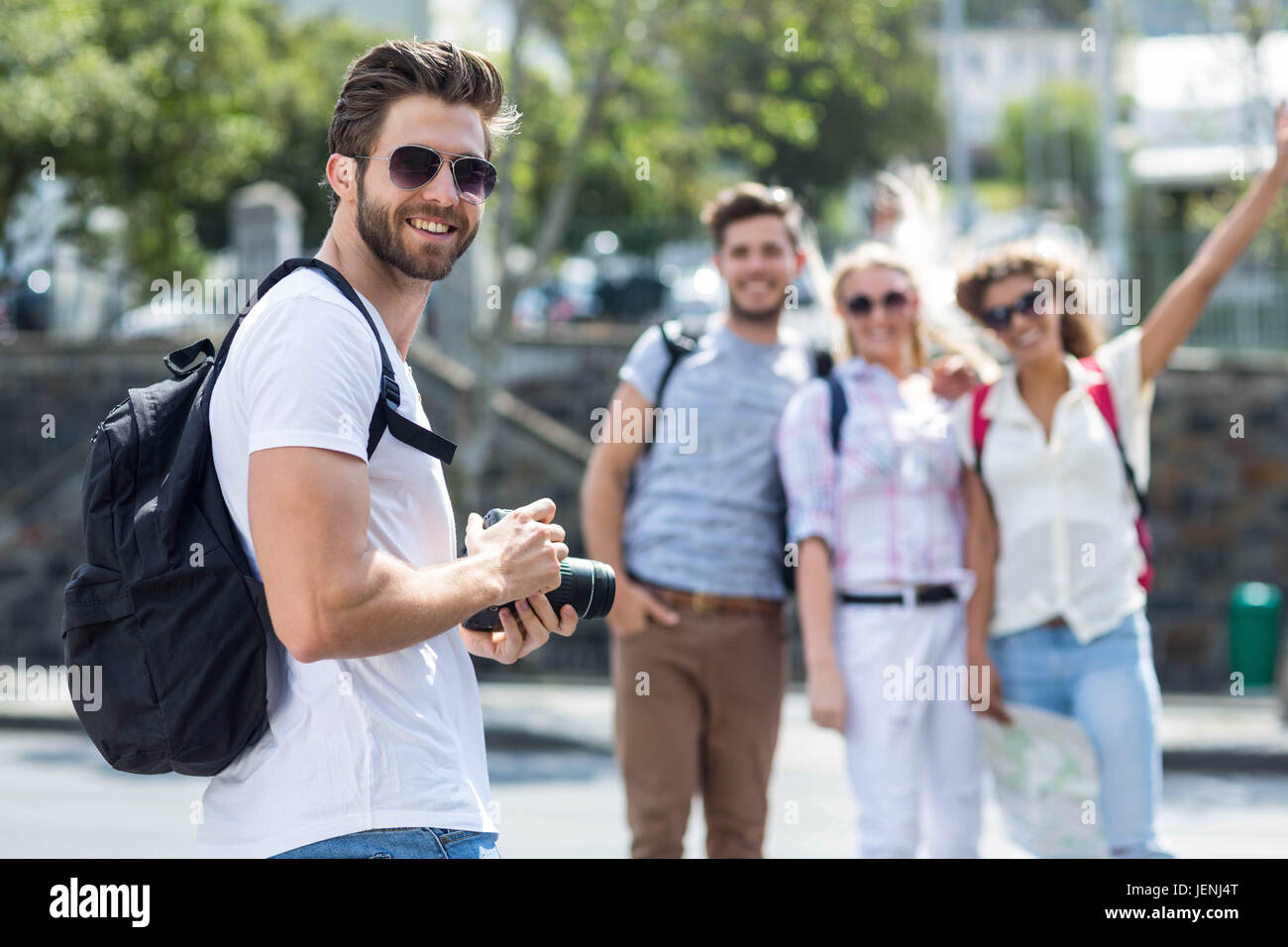 Hip man holding digital camera Stock Photo - Alamy