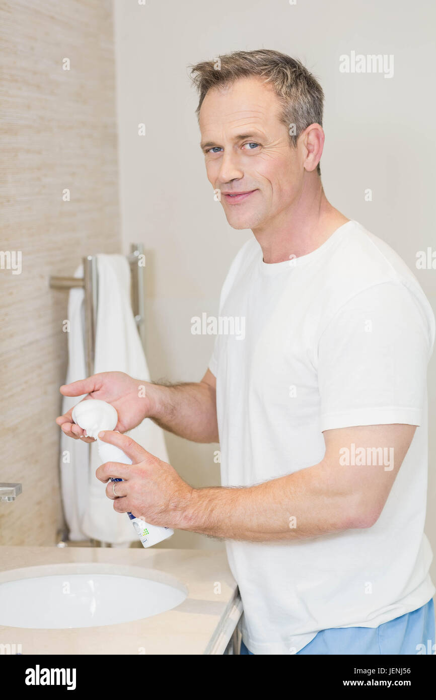 Handsome man applying cream Stock Photo - Alamy