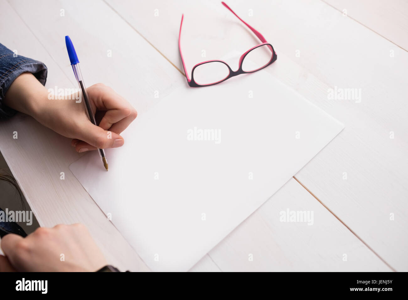 Businesswoman writing on paper table hi-res stock photography and ...