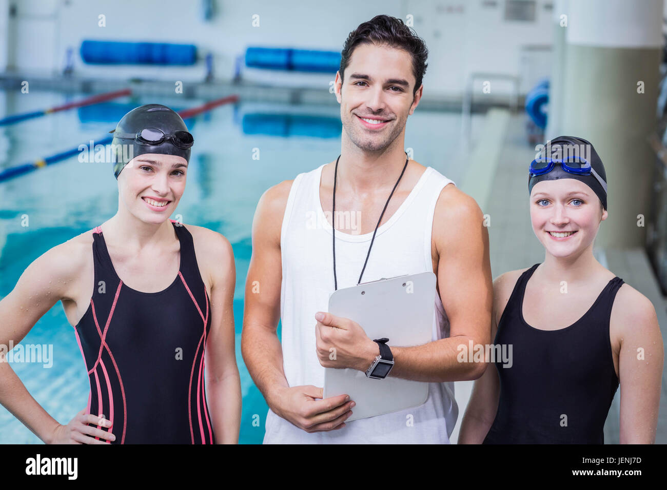 Portrait of smiling trainer and swimmers Stock Photo - Alamy