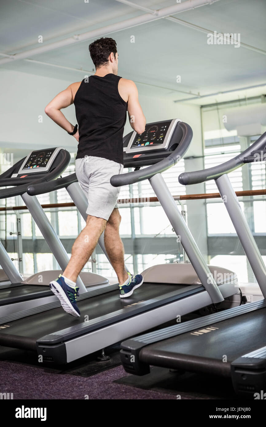 Fit man running on treadmill Stock Photo - Alamy