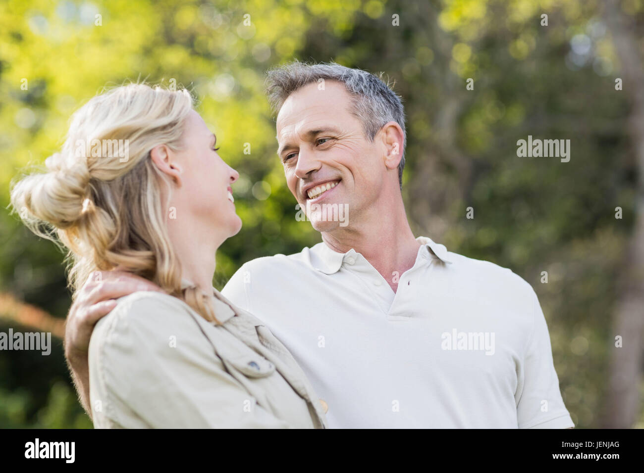 Cute couple hugging with arms around Stock Photo - Alamy