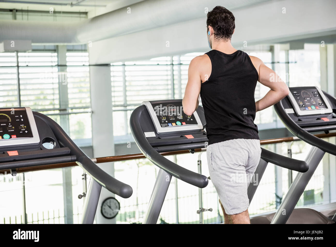 Fit man running on treadmill Stock Photo - Alamy