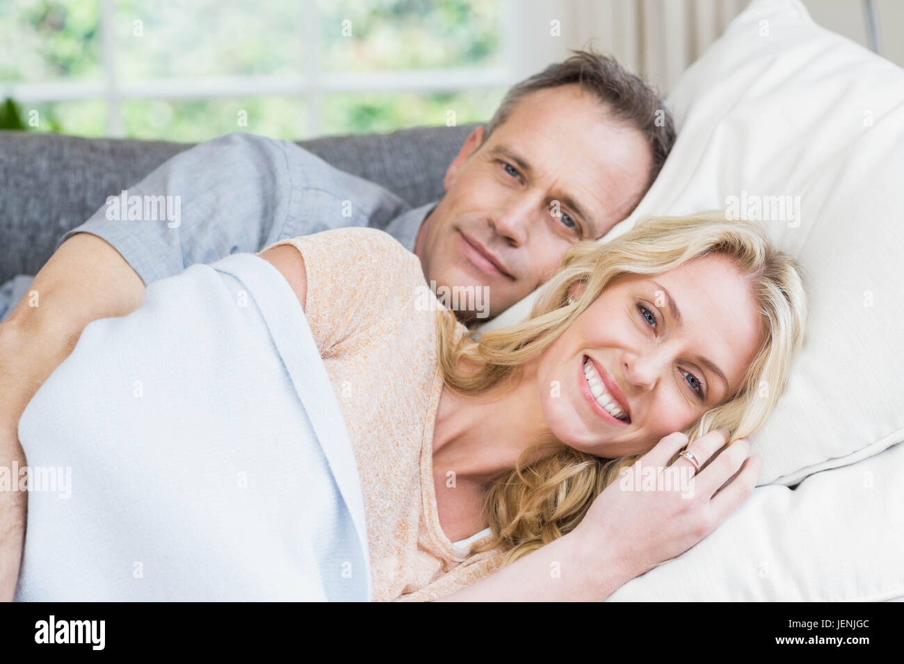 Cute couple napping on the couch Stock Photo - Alamy