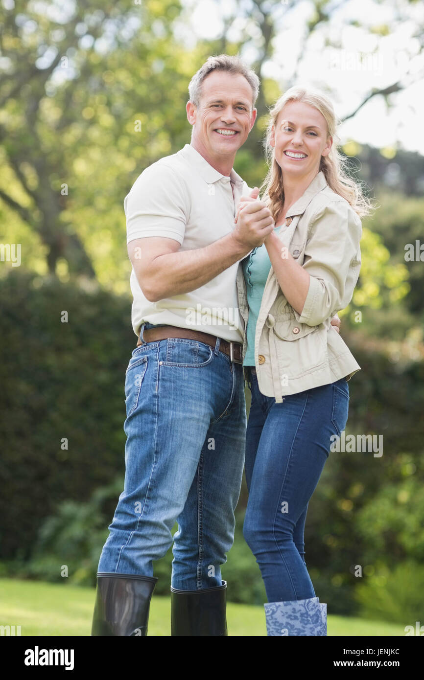 Cute couple dancing and holding hands Stock Photo - Alamy