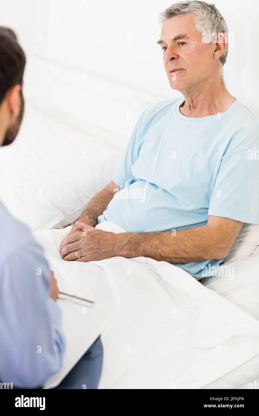 Handsome nurse visiting a mature man Stock Photo - Alamy