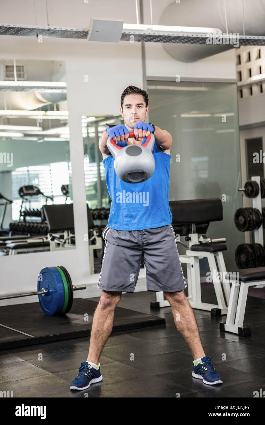 Handsome man lifting kettlebell Stock Photo - Alamy