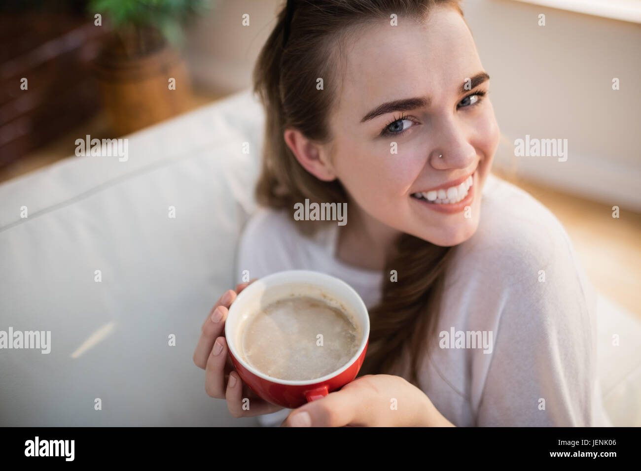 Woman relaxing indoors sipping hi-res stock photography and images - Alamy
