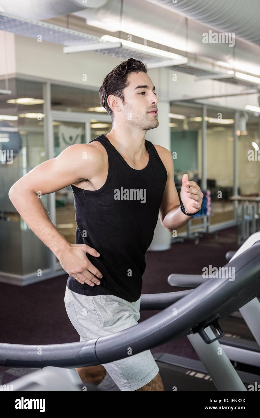 Fit man running on treadmill Stock Photo - Alamy