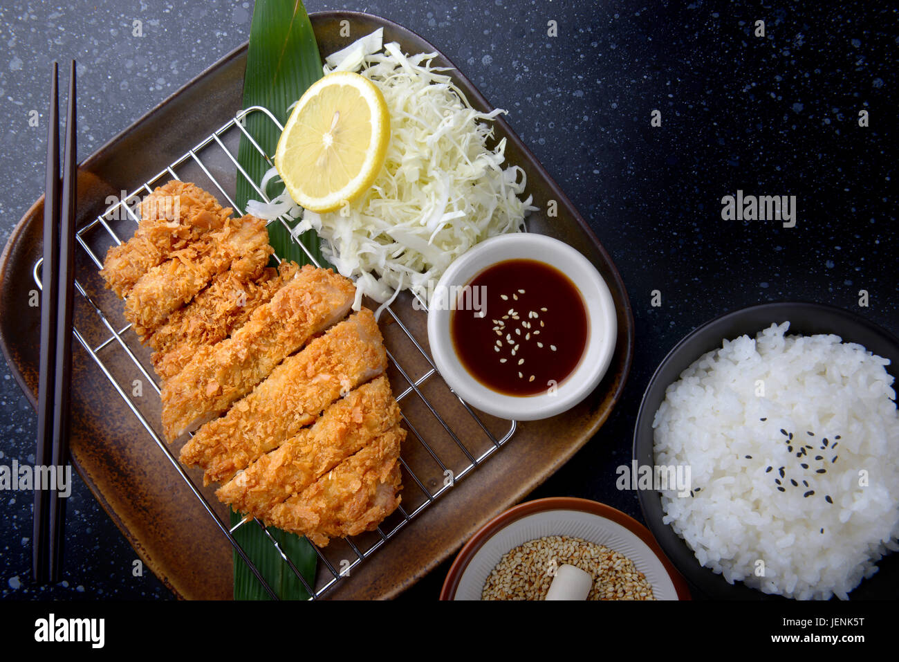 Japanese deep fried pork or tonkatsu set with rice in studio lighting ...