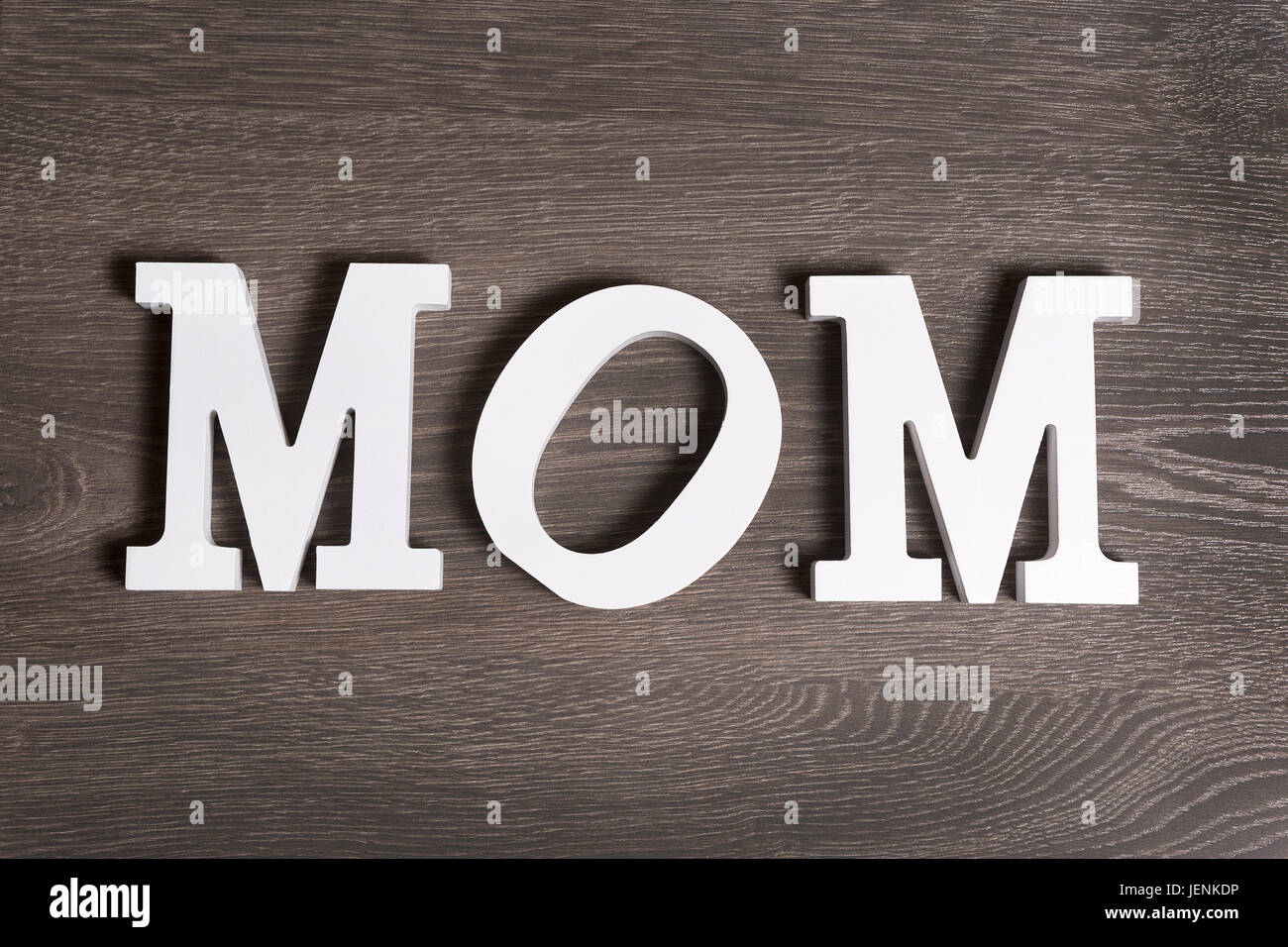 Mom, written in letters, top view on a wooden background Stock Photo ...