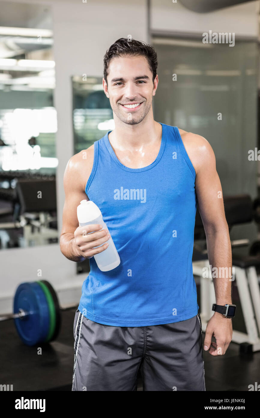 Smiling man holding bottle of water Stock Photo - Alamy