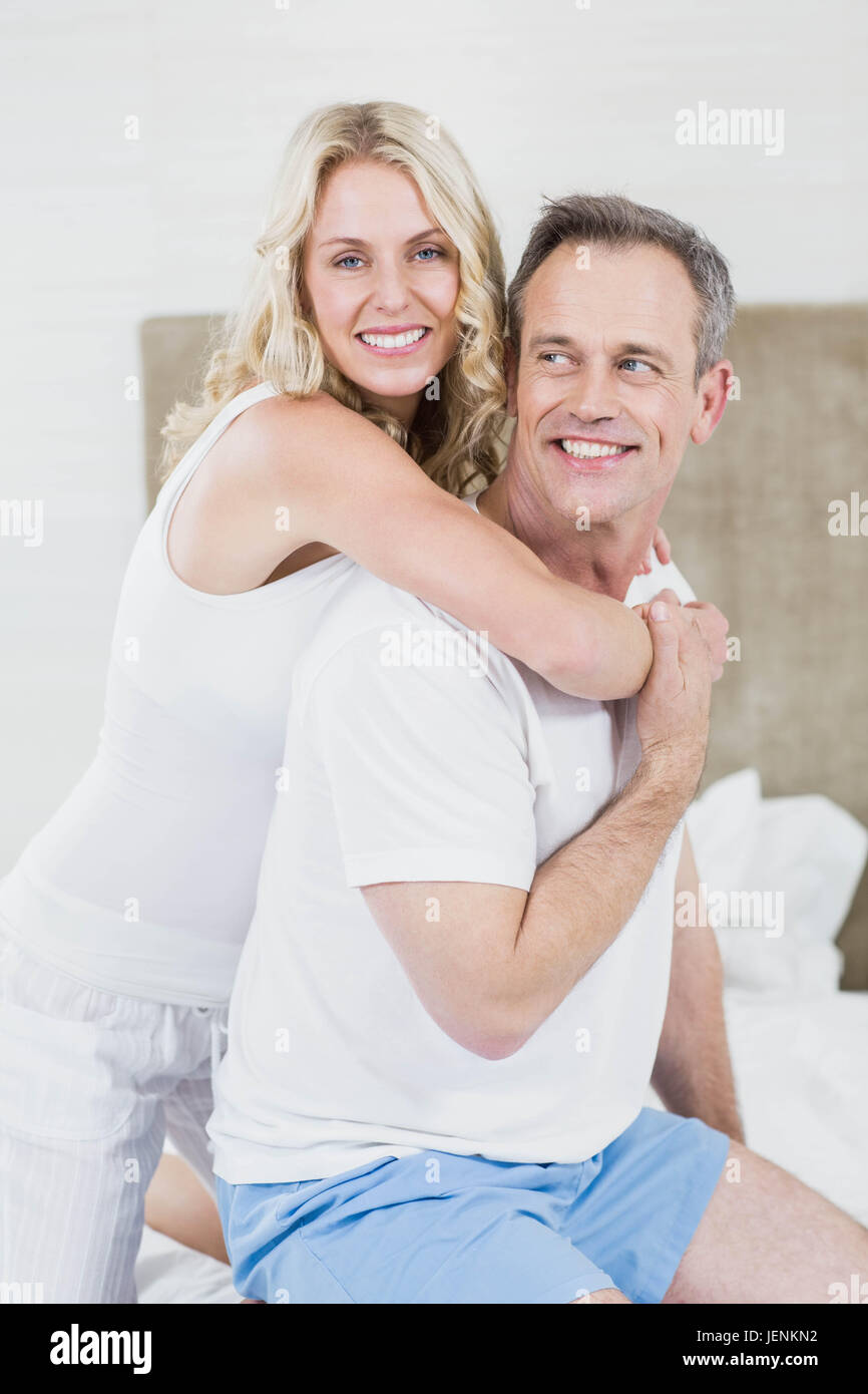 Cute couple cuddling in bed Stock Photo - Alamy