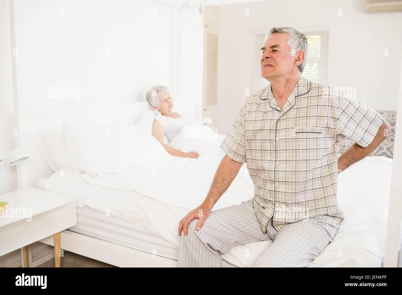 Suffering senior man holding his back Stock Photo - Alamy