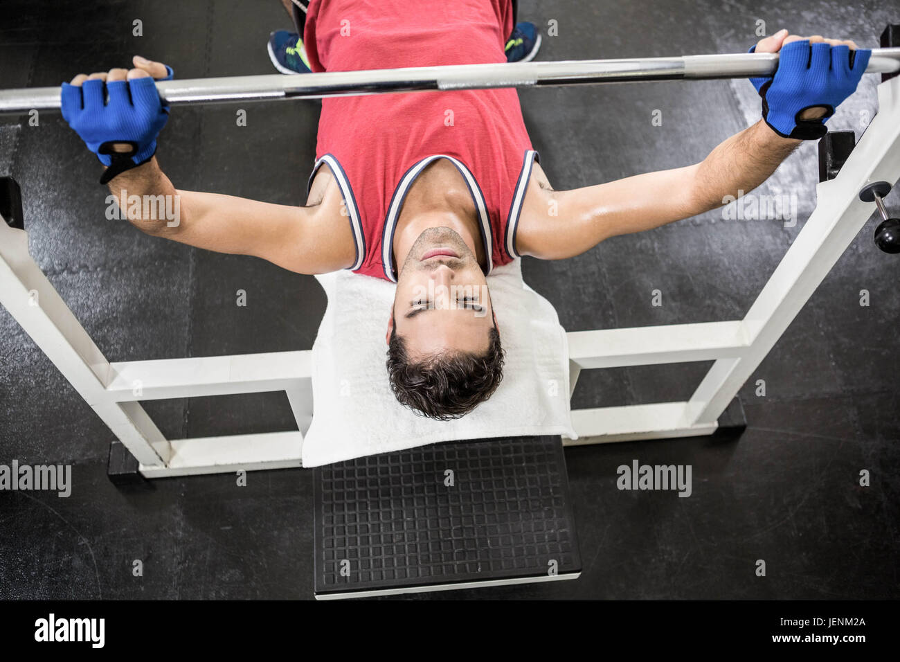 Muscular man lifting barbell on bench Stock Photo - Alamy