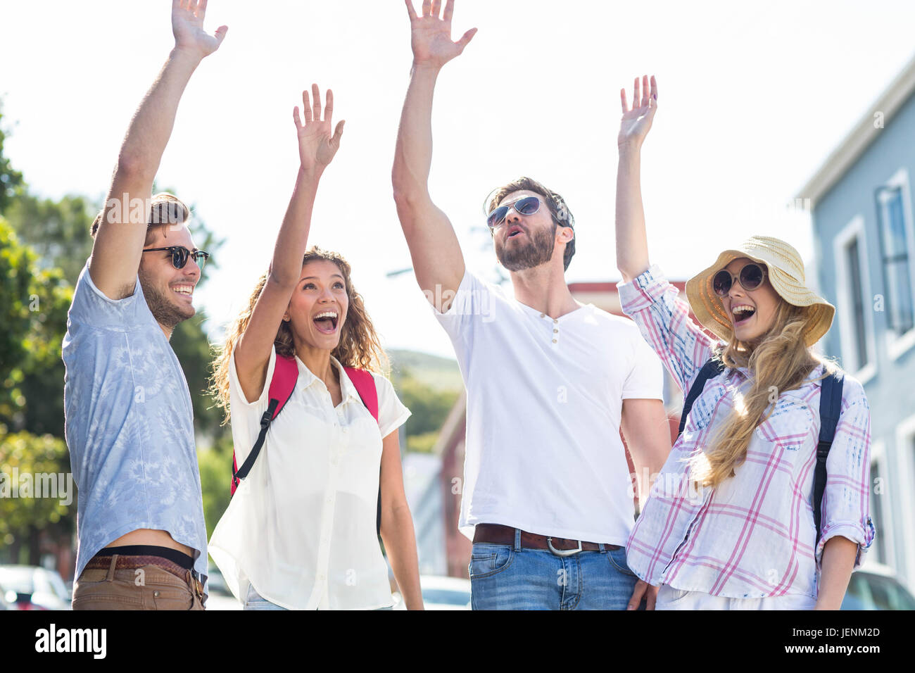 Hip friends raising hands Stock Photo - Alamy