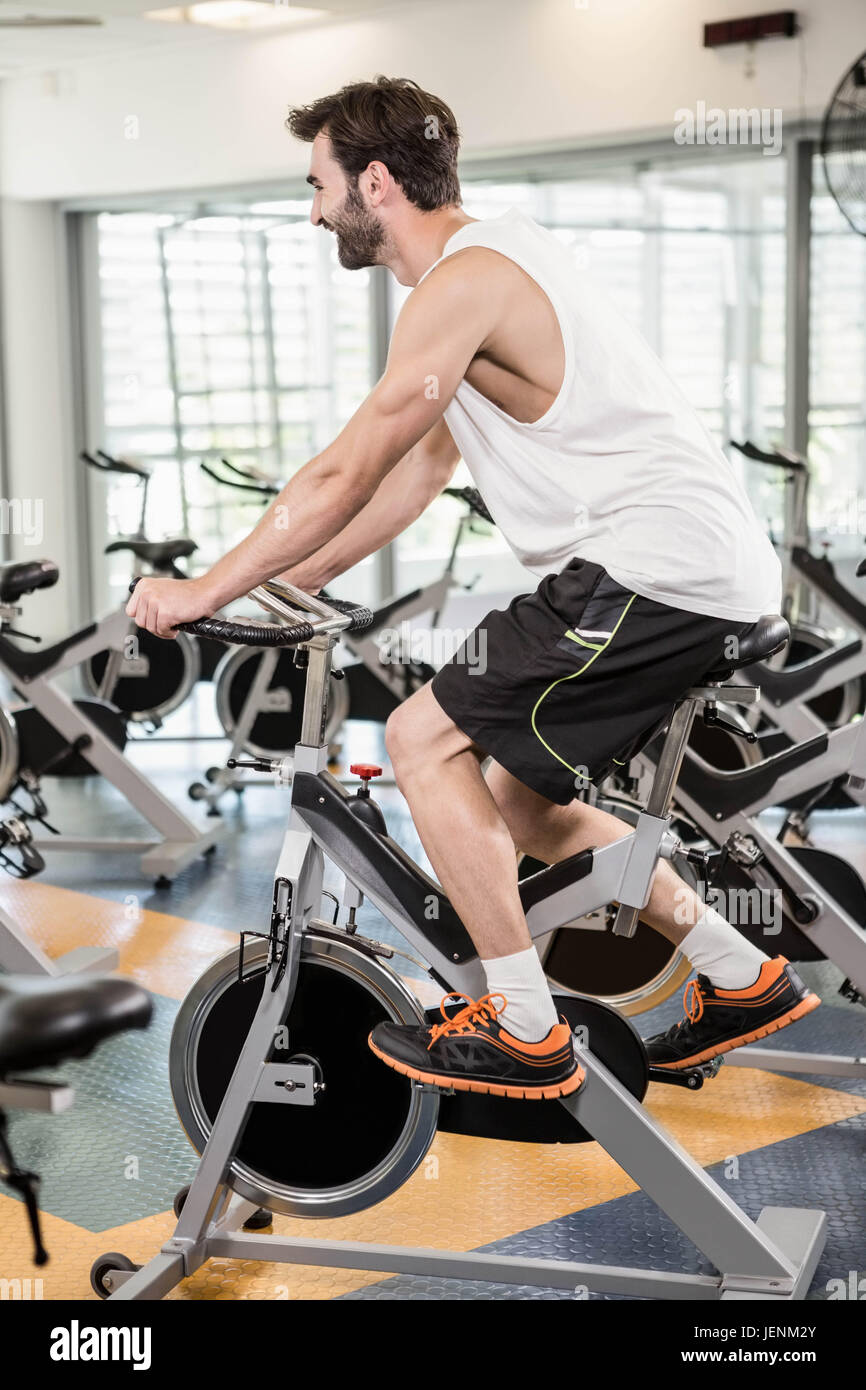 Fit man using exercise bike Stock Photo - Alamy