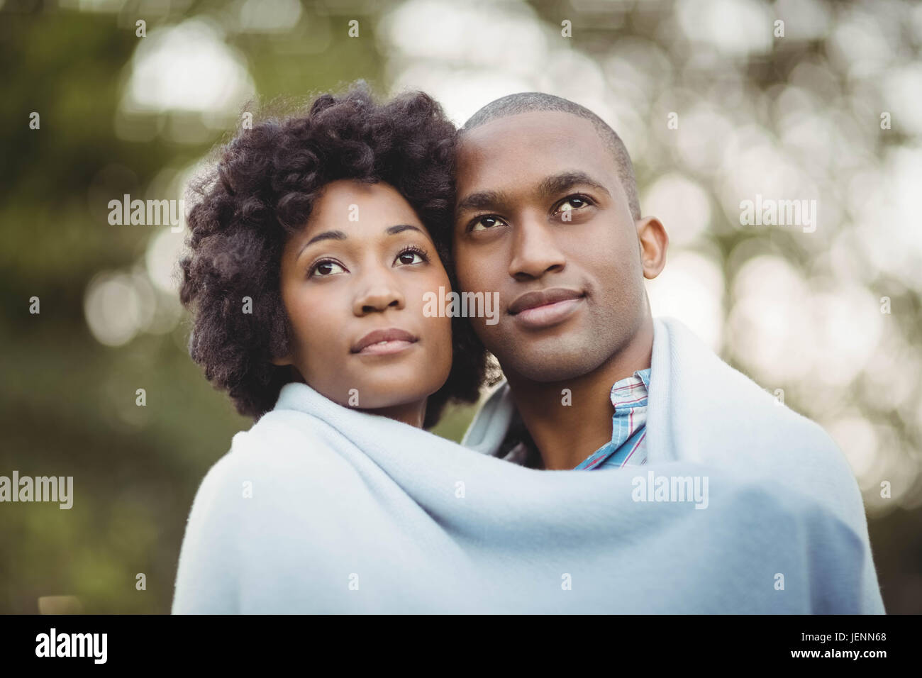 Peaceful couple under blanket looking up Stock Photo - Alamy