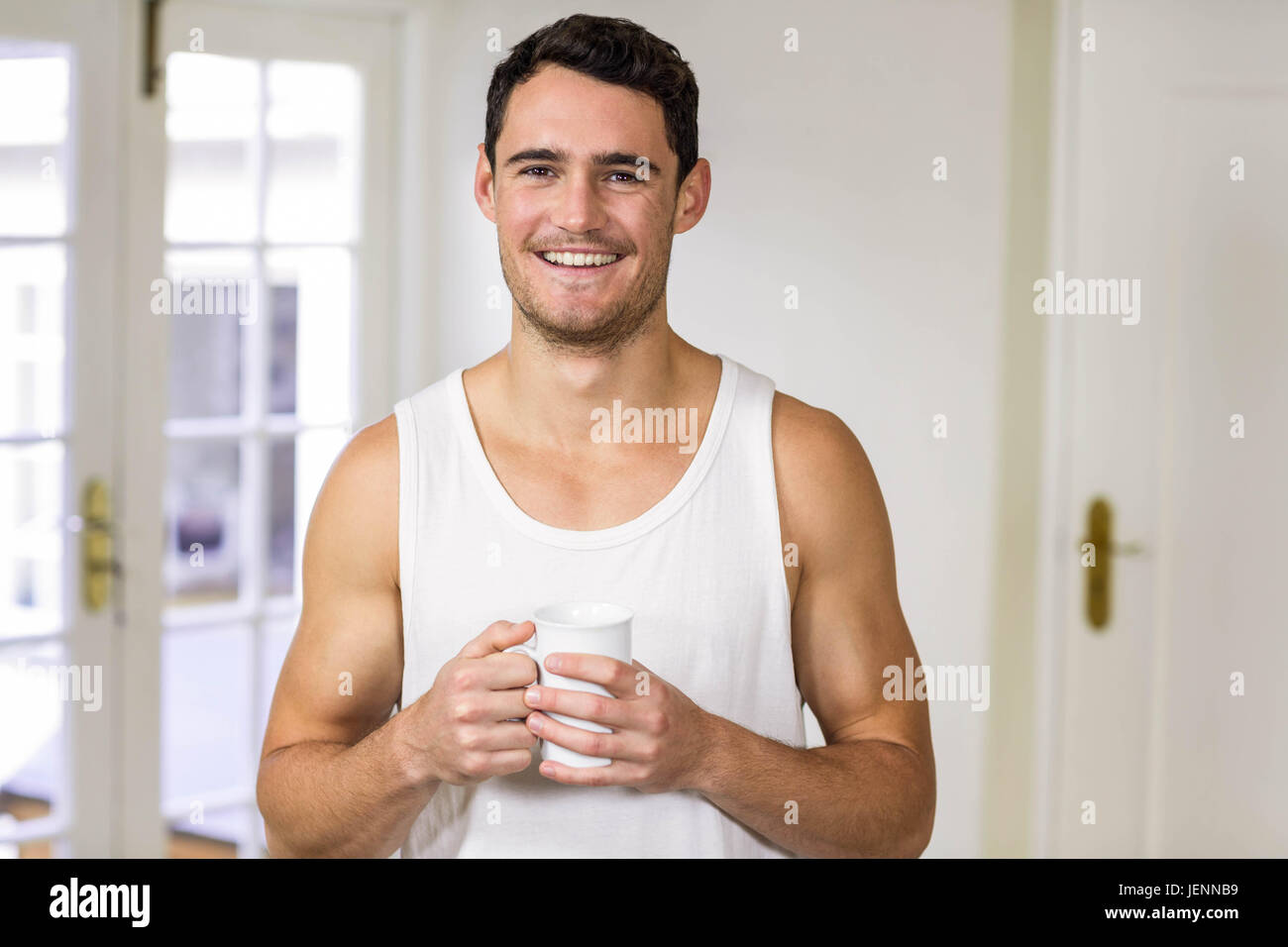 Portrait of young man holding a cup of tea Stock Photo - Alamy